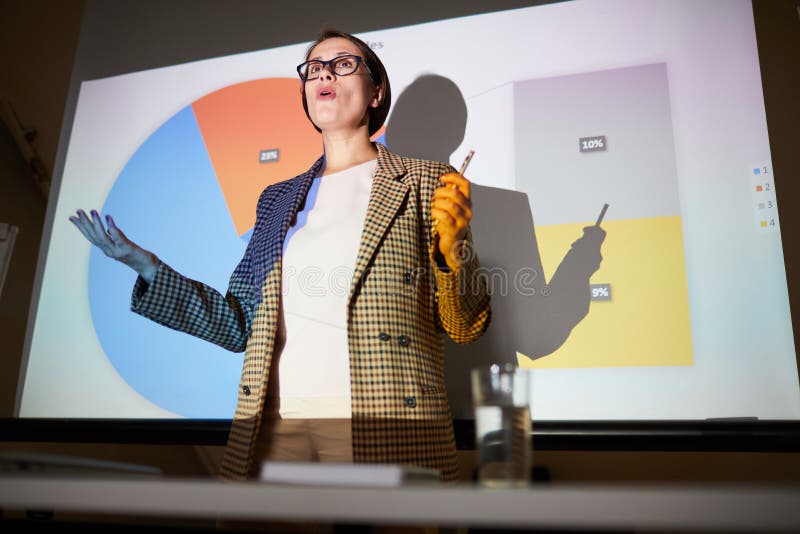 Confident Lady Explaining Data on Projection Screen Stock Image - Image ...