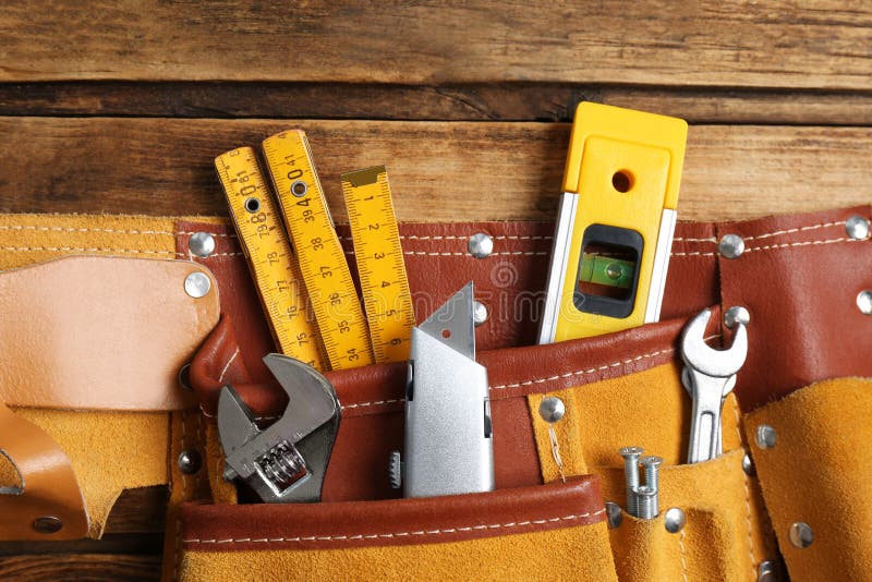 Belt with Utility Knife and Different Tools on Wooden Table, Top View ...