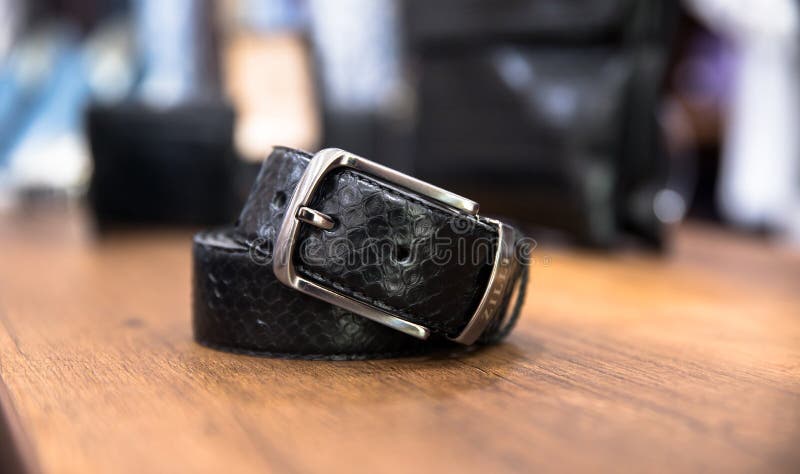 Belt on the wooden table stock photo. Image of wooden - 226346038