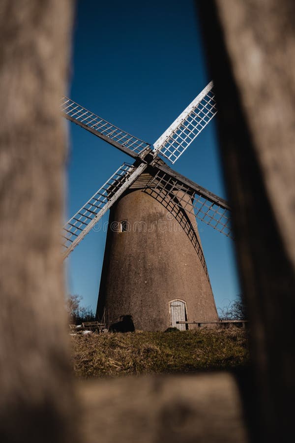 Bembridge Windmill Stands Atop a Grassy Hill, Its Sails Silhouetted ...