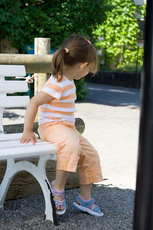 Crying Girl Sitting on the Bench on Background of the Playground Stock ...