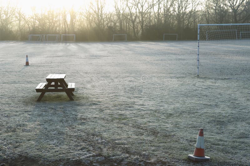 Bench and Bollards on Empty Soccer Field at Sunset Stock Image - Image ...