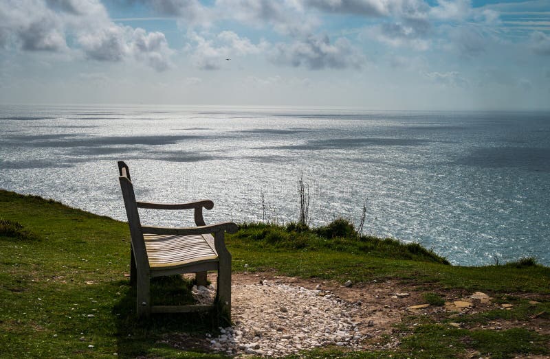 A Bench on the Cliff Against Sea View Stock Photo - Image of land, rock ...