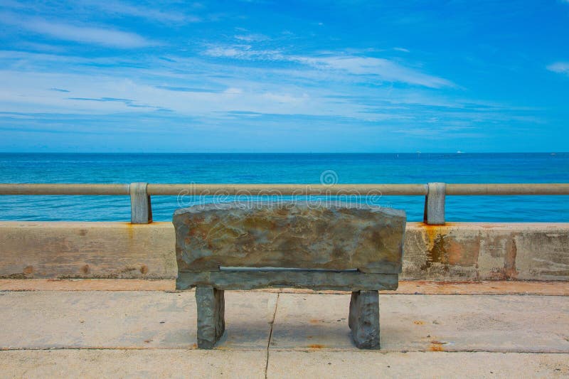 The Bench is Empty by the Ocean and a Wall and the Railing Stock Image ...