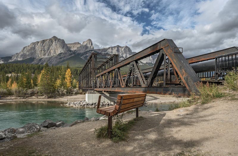 Bench an Engine Bridge in Canmore Stock Image - Image of river ...