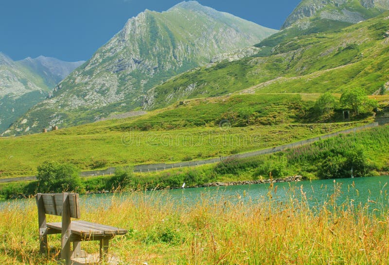 Bench facing the mountains stock image. Image of grass - 60475777