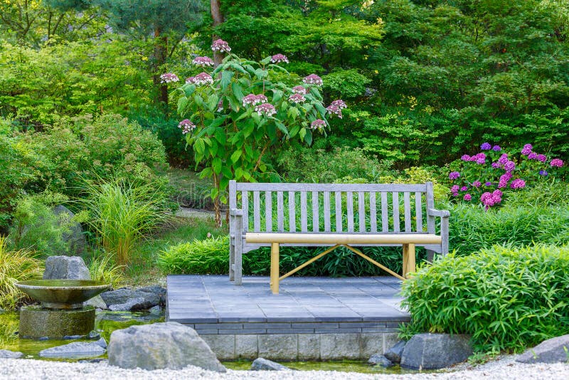Bench and flowers in park stock photo. Image of green - 76402518
