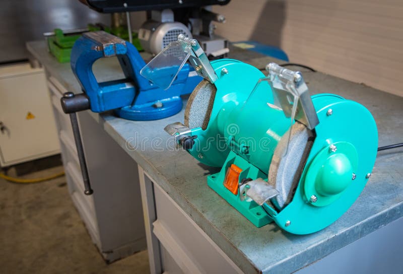 Bench Grinder Sitting on Workbench Next To Vise in Workshop Stock Image ...