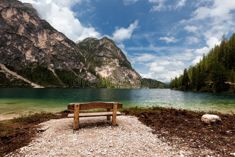 Bench near mountain lake stock photo. Image of alpine - 52636644