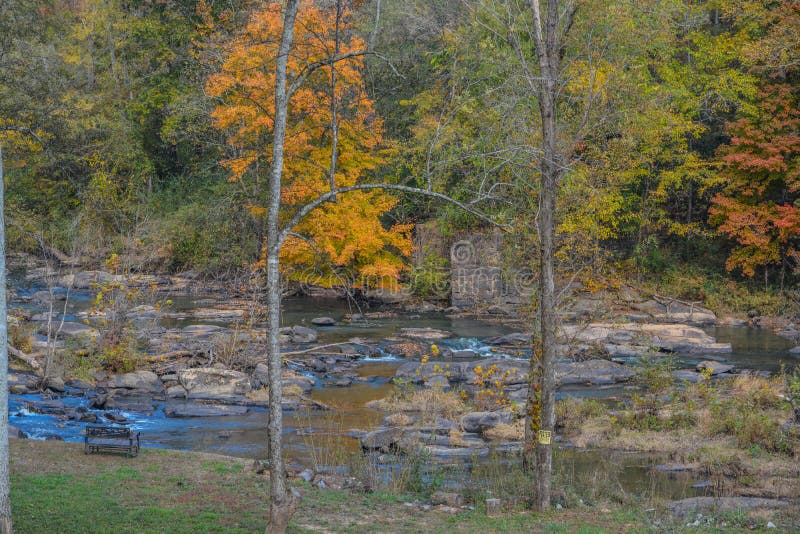 A Bench Next To Ogeechee River Flowing Over the River Rock in the ...