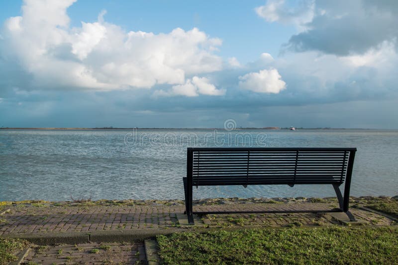 Bench Overlooking the Sea with Clouds Stock Image - Image of loneliness ...