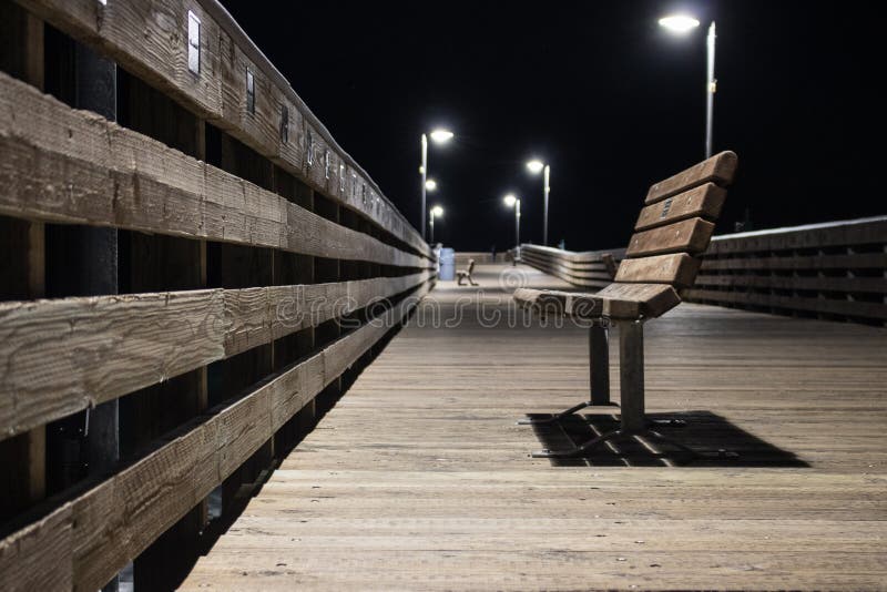 Bench on pier at night stock image. Image of bench, beach - 110511229