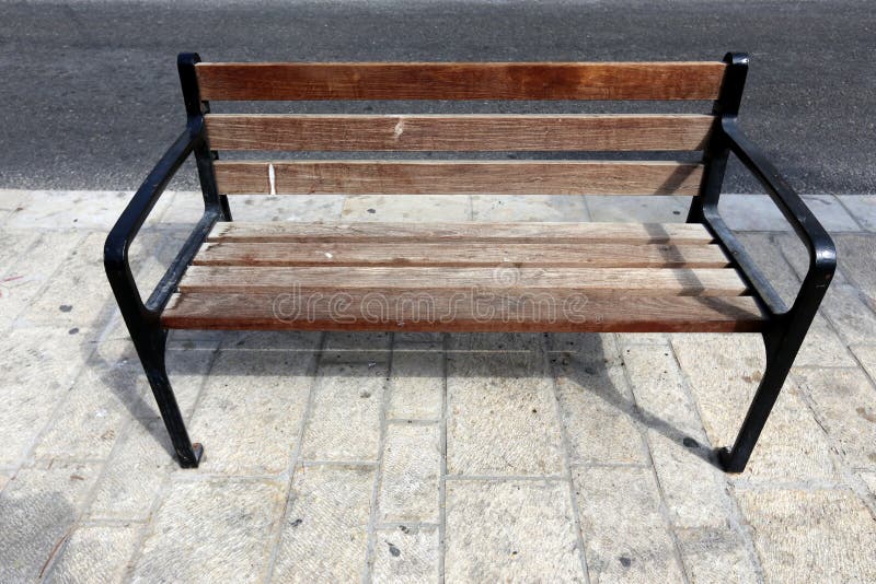 Bench Resting on the Sidewalk in the City Stock Photo - Image of stands ...
