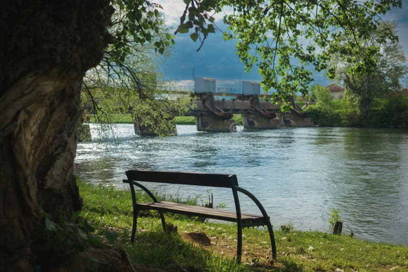 A Bench by the River with a Dam Stock Image - Image of peaceful, park ...