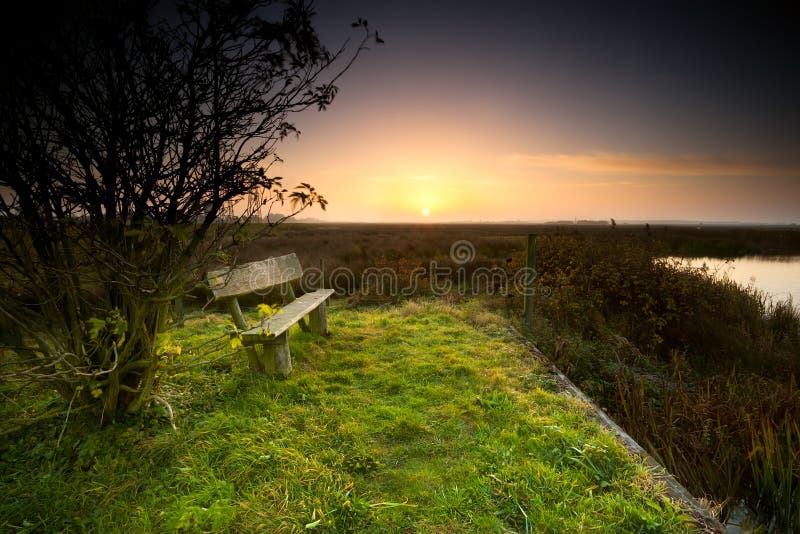 Bench by river at sunrise stock image. Image of relax - 29379551