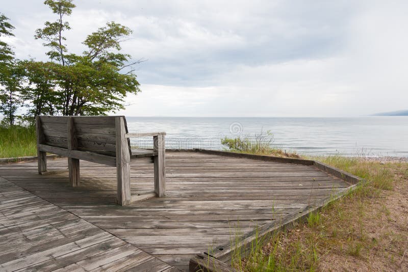 Bench on Shoreline with Clouds Stock Image - Image of coast, platform ...