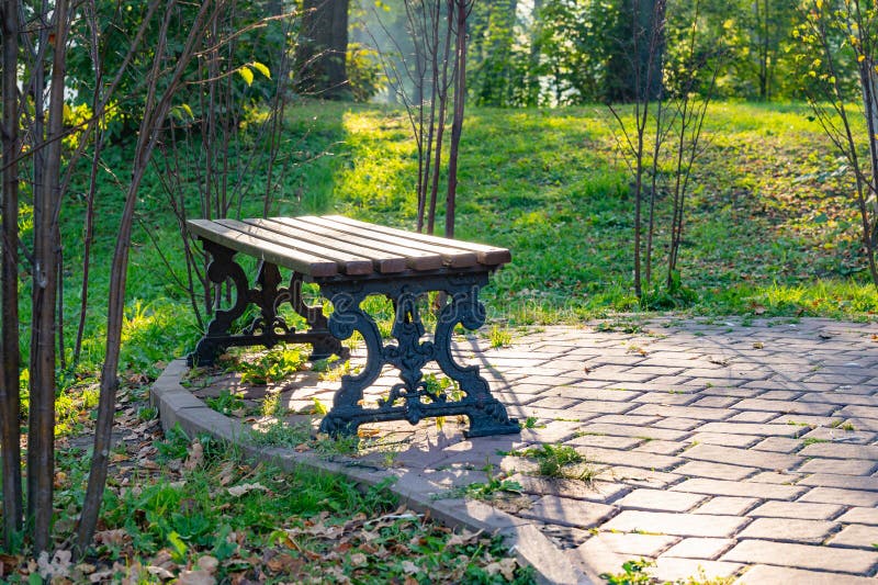 Bench is Sitting on a Brick Path in a Park Stock Image - Image of seat ...