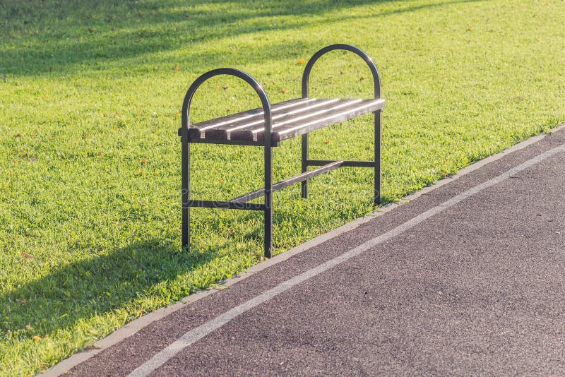 Bench by the small road stock photo. Image of green - 189128400