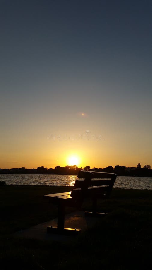 Bench at sunset stock image. Image of christchurch, beach - 90834639