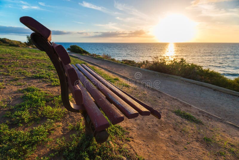 Bench at sunset stock photo. Image of flare, bench, coastline - 53948712