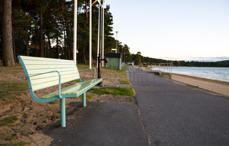 Bench by a Walkway by the Water Stock Photo - Image of bench, water ...