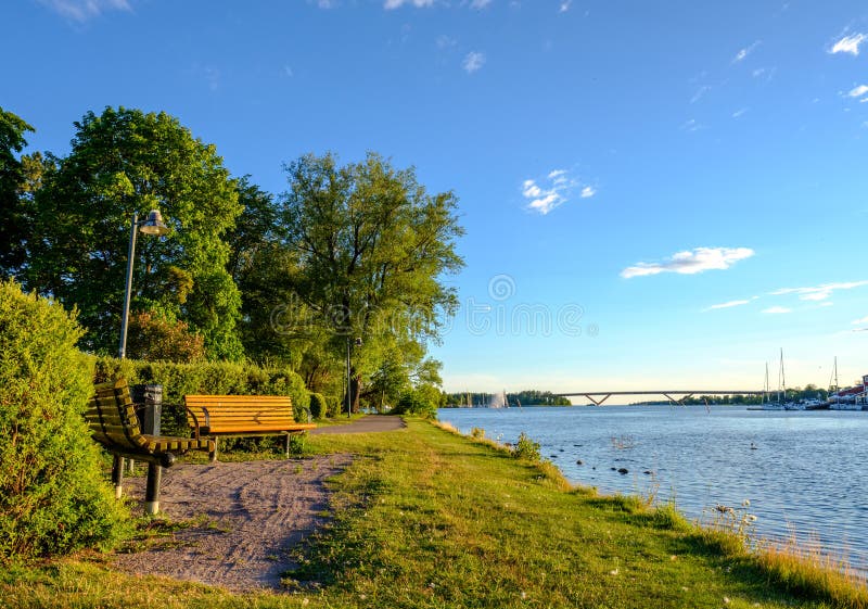 Benches by the water stock photo. Image of land, sunlight - 97420914