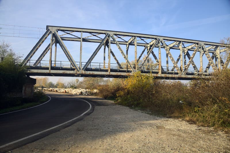 Bend in a Country Road Under a Railroad Bridge Stock Photo - Image of ...