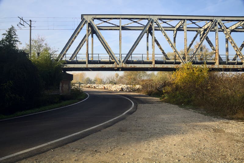 Bend in a Country Road Under a Railroad Bridge Stock Image - Image of ...