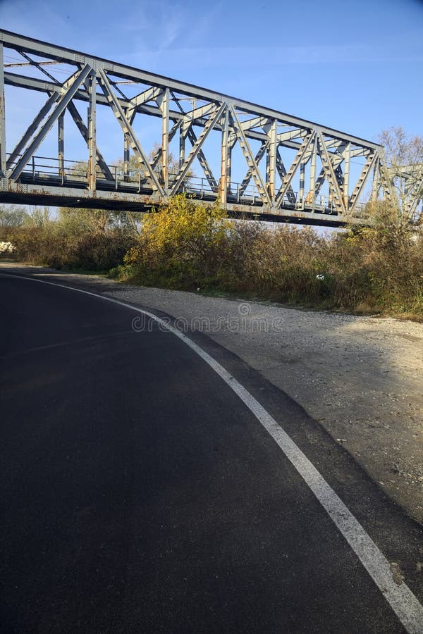 Bend in a Country Road Under a Railroad Bridge Stock Image - Image of ...