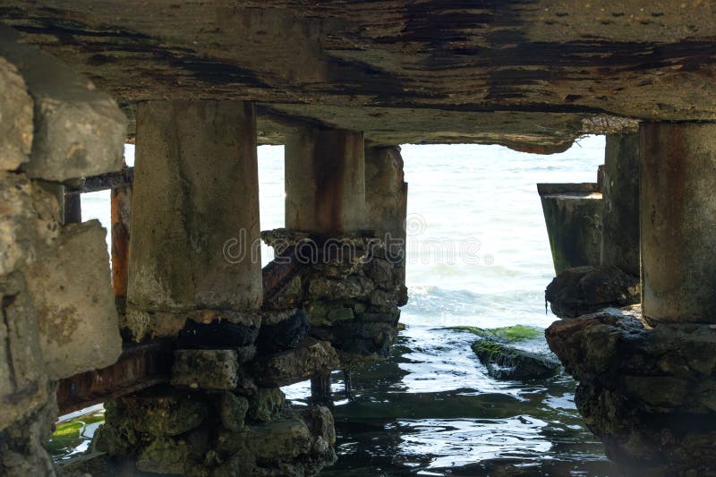 Beneath the Crumbling Concrete Structure, the Sea is Visible, with ...