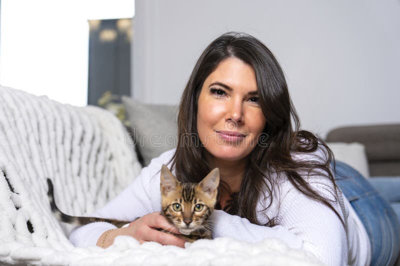 Bengal Cat In The Living Room On The Couch With A Woman Stock Image Image Of Living Little
