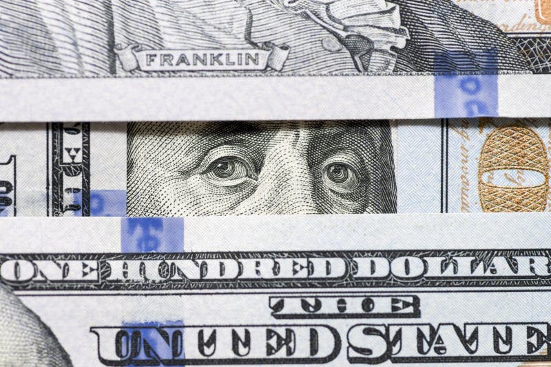 Benjamin Franklin`s Eyes between Hundred Dollar Banknotes Close-up ...