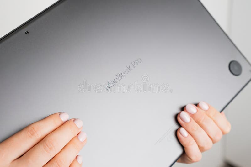 Macbook Pro in womans hand editorial photography. Image of screen ...