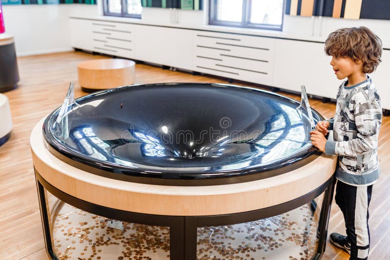 Small Child is Making Experiment with Gravity in a Physical Museum ...