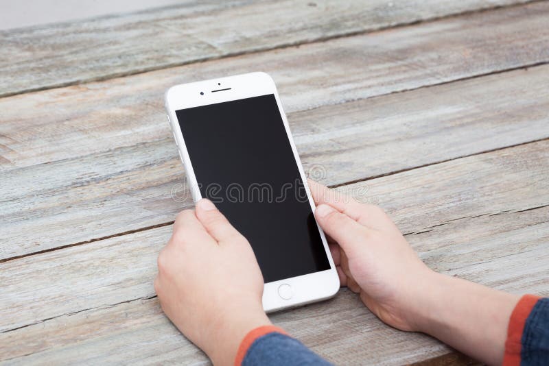 Boy holding iPhone 7 Plus editorial stock photo. Image of iphone ...
