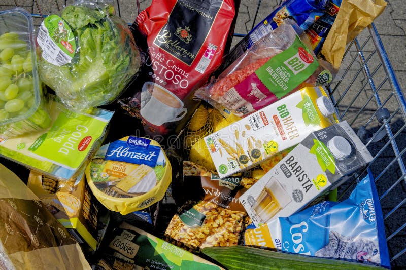 A Full Shopping Cart with Various Products for daily Needs Editorial ...