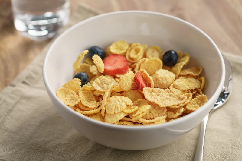 Berries Falling into Corn Flakes for Breakfast in Bowl on Table Stock ...
