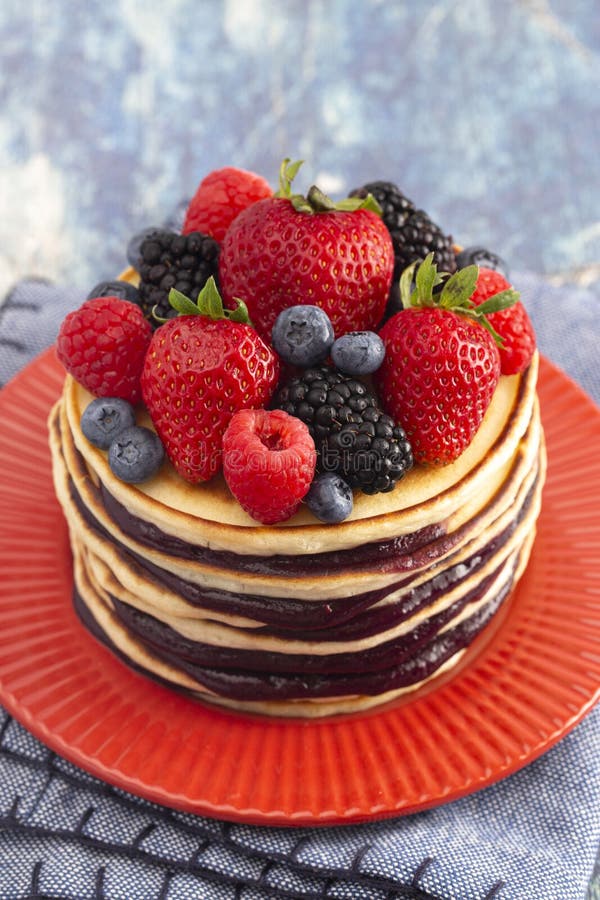 Berry Pancakes with Compote Spread on a Rustic Blue Wood Table Stock ...