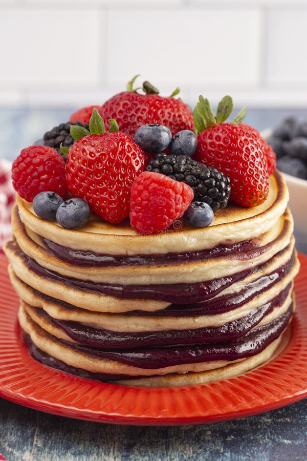 Berry Pancakes with Compote Spread on a Rustic Blue Wood Table Stock ...