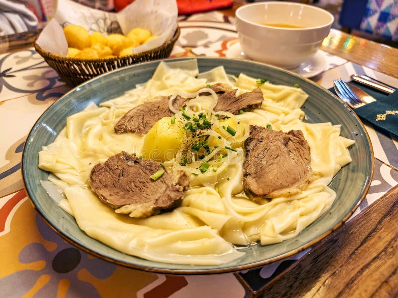 Beshbarmak from Beef Square-shaped Pasta, Fried Onions and Parsley on a ...