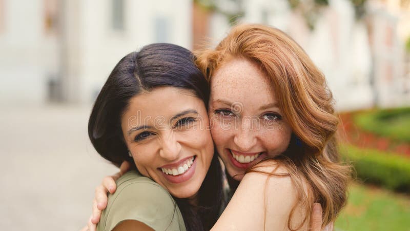 Best Friends Embracing while Smiling in the Street Stock Image - Image ...