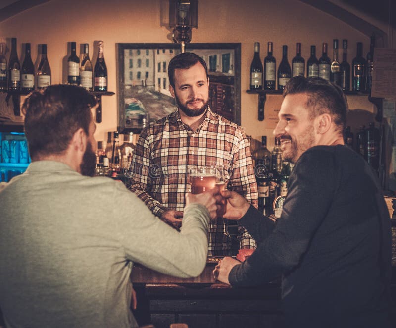 Best Friends Having Fun and Drinking Draft Beer at Bar Counter in Pub ...