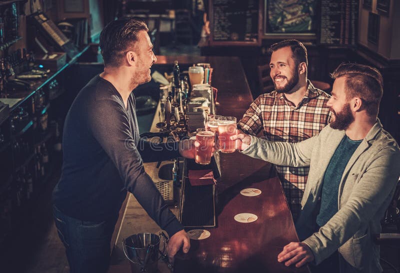 Best Friends Having Fun and Drinking Draft Beer at Bar Counter in Pub ...