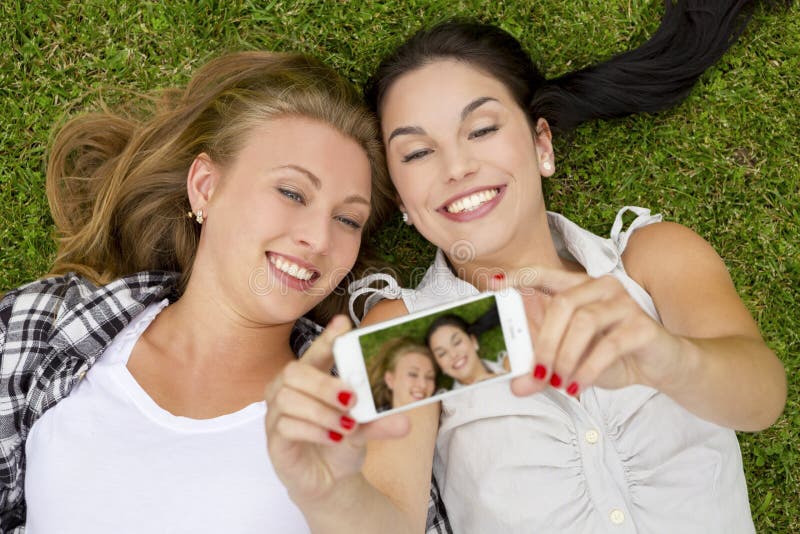 Best Friends Taking Selfies Stock Image - Image of lying, cute: 49332507