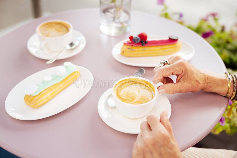 Lickerish Eclair and Coffee Putting on Surface Stock Photo - Image of ...