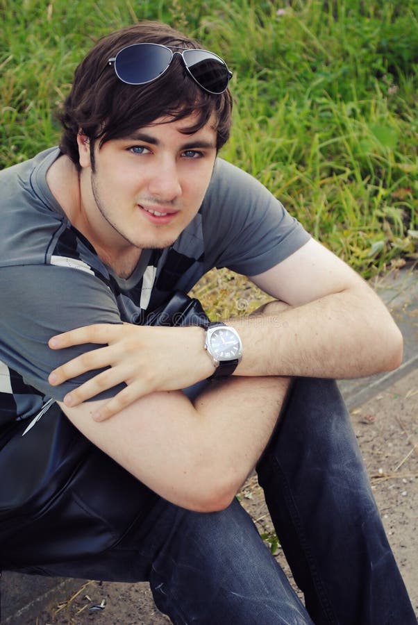 Beutiful Young Boy is Seating on the Grass Stock Photo - Image of male ...