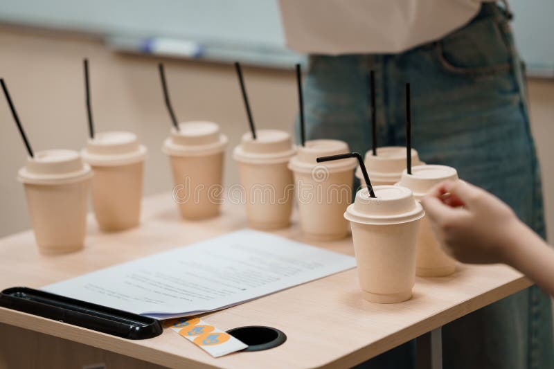 Beverage Sampling Event: Array of Paper Cups and Hand Reaching, Light ...