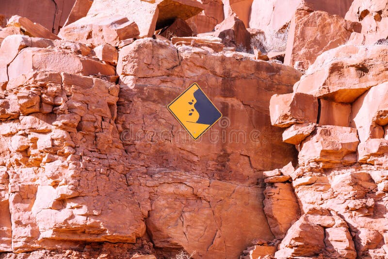 A Beware of Falling Rocks Sign Posted To a Cliff of Red Rocks in Utah ...