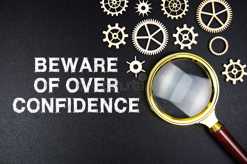 Beware of Over Confidence Text Message with Magnifying Glass on Black ...