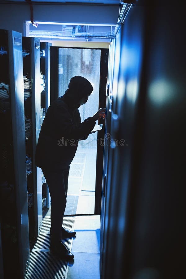 Beware of Thieves in the Night. a Hacker Using a Digital Tablet in a ...